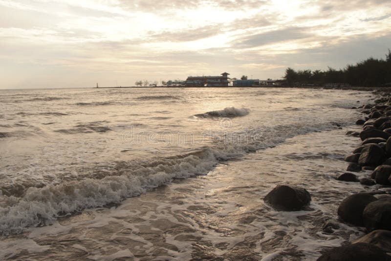 Beach Atmosphere with Small Waves Hitting the Rocks Stock Image - Image ...
