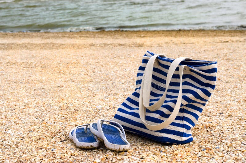 Beach Bag and Slippers on the Beach by the Sea Stock Photo - Image of ...