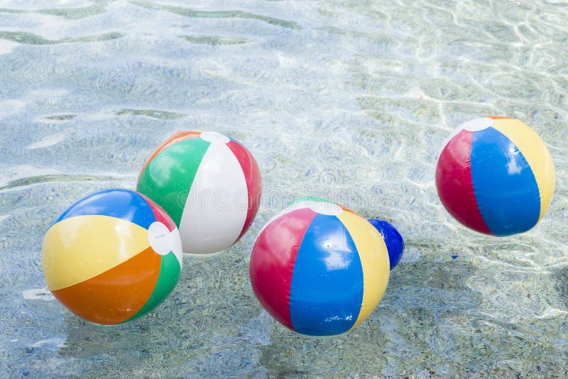 Beach balls in pool stock image. Image of balls, colors - 76285307