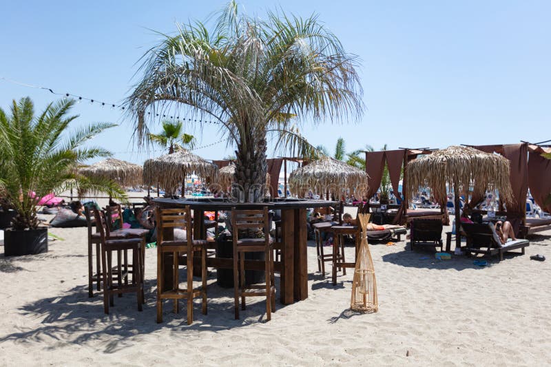 Beach Bar with a Wooden Table and Palm Trees Stock Photo - Image of ...