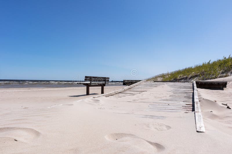 .beach with a Bench and a Concrete Path Leading To the Sea Stock Photo ...