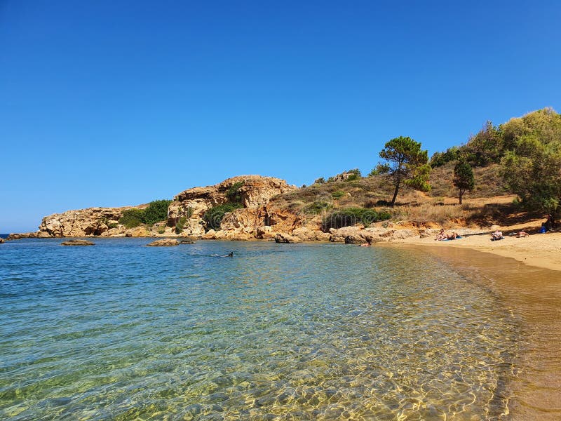 Beach with Blue Sky, Crystal Clear Water and Rocks Stock Image - Image ...