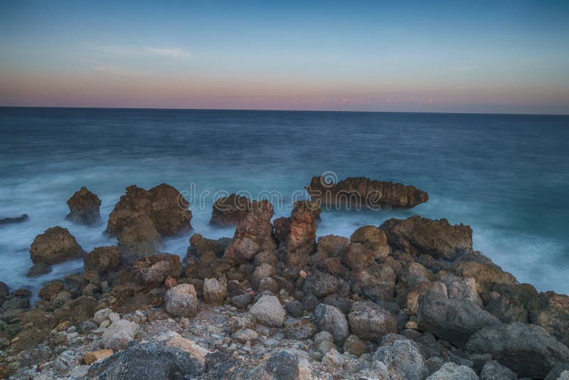 Beach and Boulder View at Sunset Stock Photo - Image of ocean, cliff ...