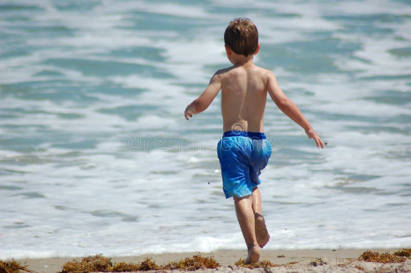 Beach Boy stock image. Image of blue, playing, beach, seaweed - 2299517