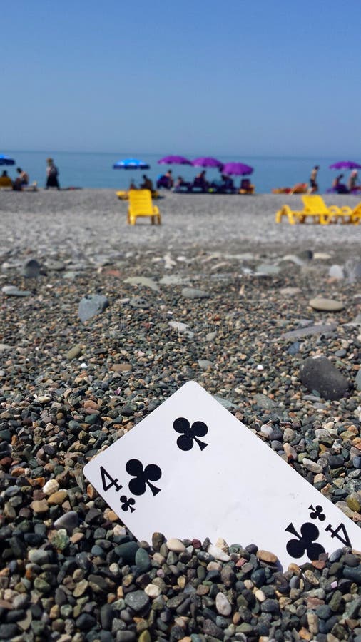 Playing card on the beach stock image. Image of rocks - 43616189