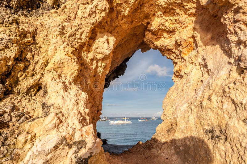 Beach cave stock image. Image of beach, sunlight, rocks - 89945423