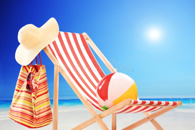 Beach Chair with Ball, Bag and Hat by the Sea Stock Photo - Image of ...