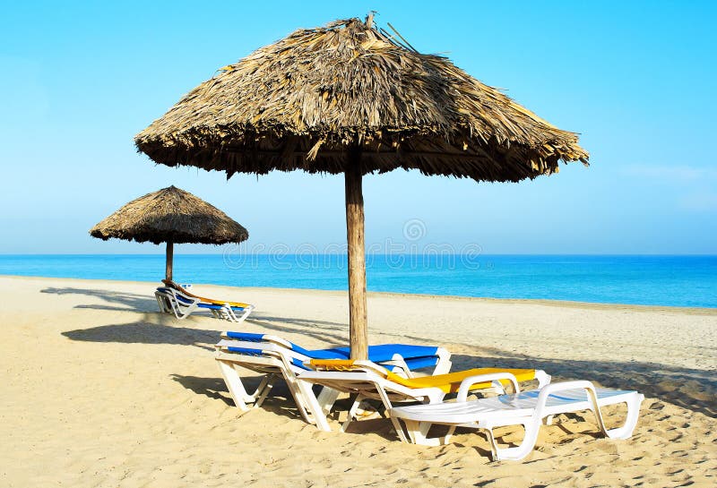 Beach Chair Under Rustic Umbrellas in the Beach Stock Photo - Image of ...
