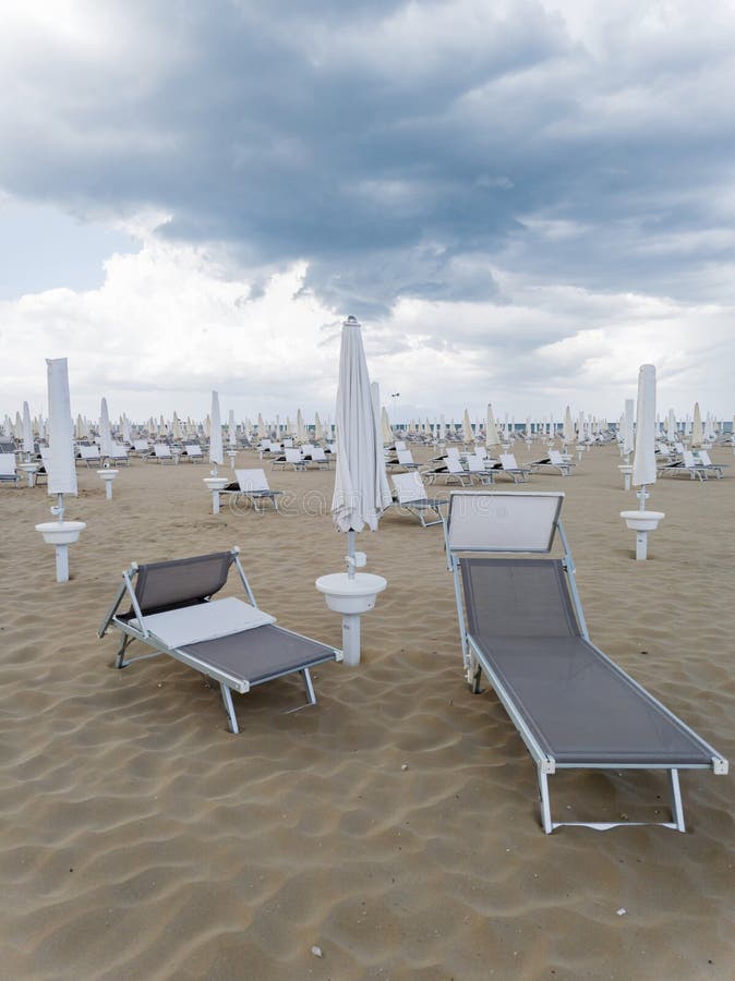 Beach Chairs Stand on an Empty Beach Stock Photo - Image of parasol ...