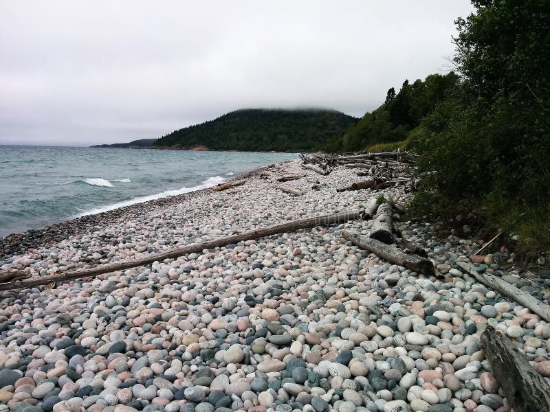 Beach with Colorful Rocks and Trees Stock Image - Image of blue, stone ...