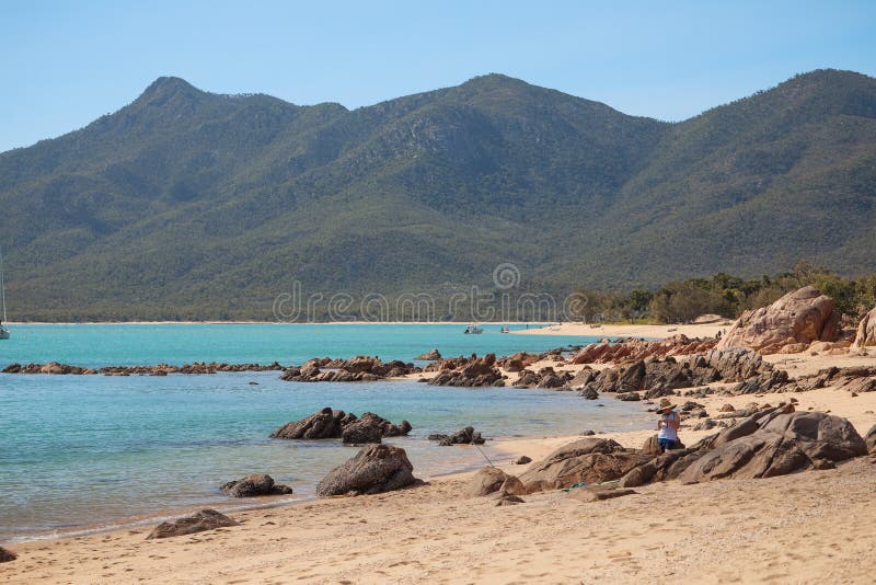Beach Covered in Rocks Surrounded by the Sea and Hills Covered in ...