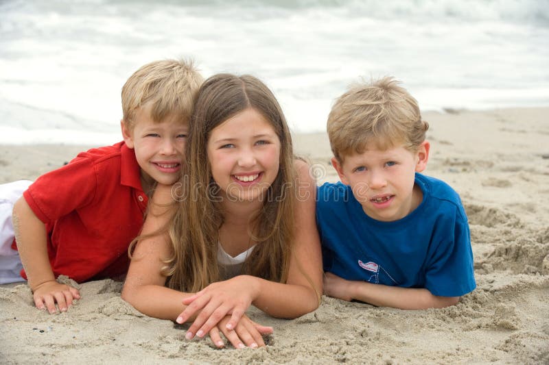 Three children on beach stock photo. Image of children - 2626296