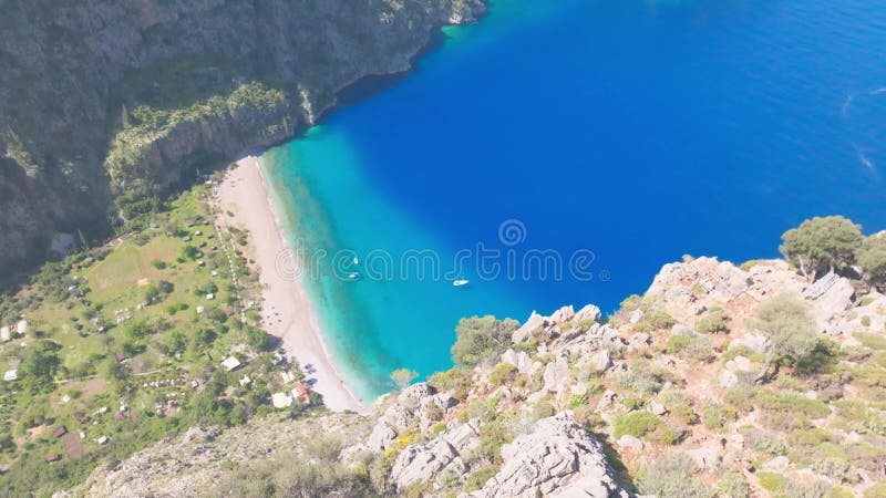 Beach with Deep Blue Waters, Green Space and Rugged Mountains in the ...