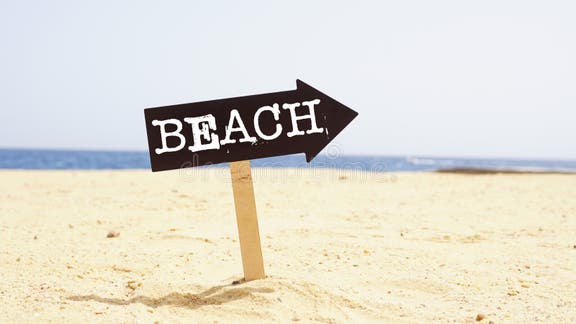 Beach Directional Sign Pole on Sand in Front of the Sea Stock Photo ...
