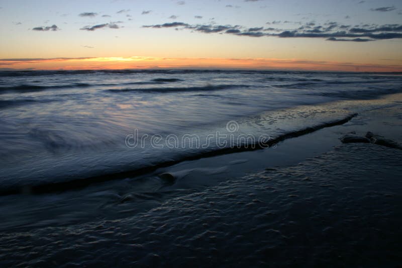 Beach at dusk stock photo. Image of waves, sunset, blue - 34435728