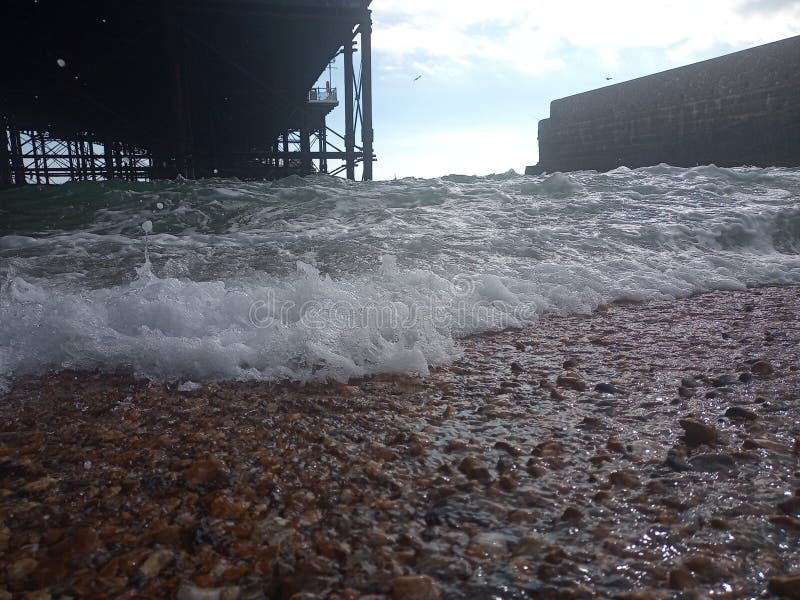 Beach Front Under Pier Waves Ocean Water Brown Metal Objects Stock ...