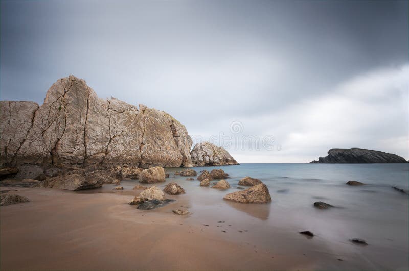 Beach Full of Rocks with Cloudy Sky, Spain Stock Image - Image of ...