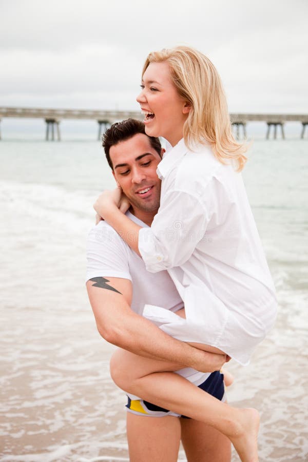 Beach Huddle stock image. Image of back, ocean, laughing - 12830963
