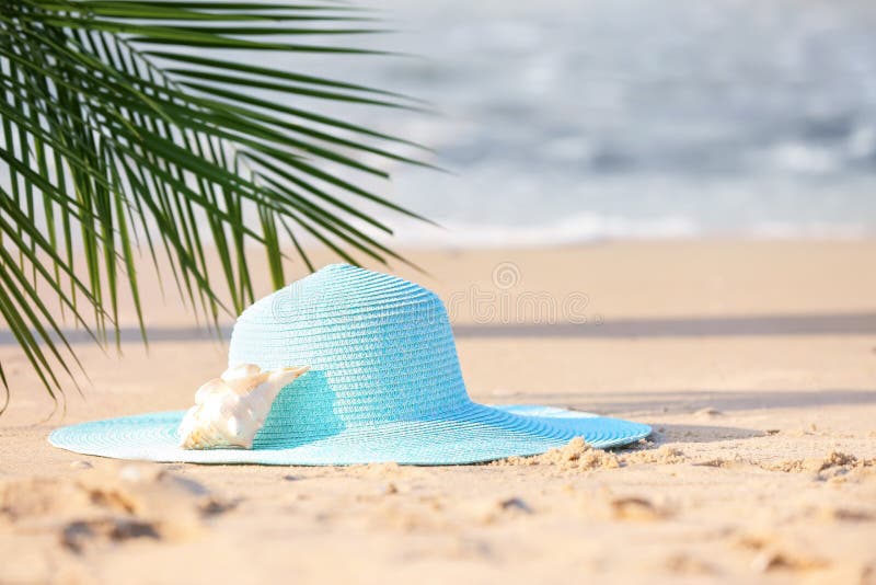 Beach Hat with Seashell on Sand Near Sea Stock Image - Image of ...