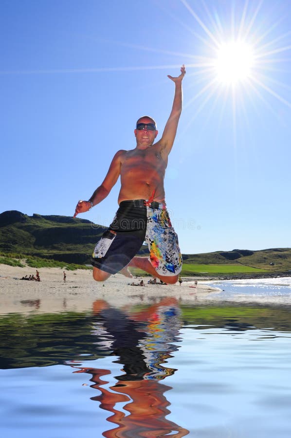 Beach jump stock photo. Image of jumping, reflection, mountain - 6001948