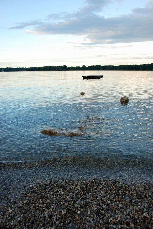 Beach on lake after sunset stock image. Image of rocks - 23079753
