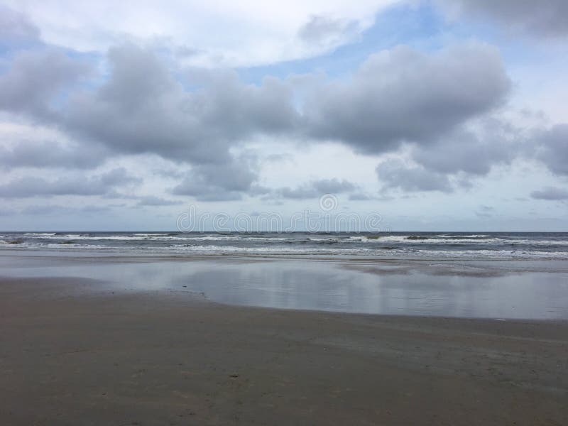 Gray Beach Chairs And Parasols On Sandy Beach With Cloudy Blue S Stock ...
