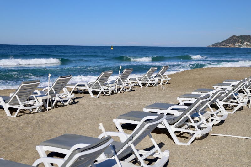 Beach lounge chairs stock image. Image of holiday, scenic - 379011549