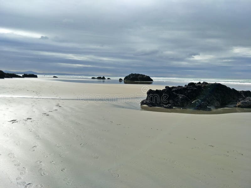 Beach with Overcast Skyand Thick White Clouds Stock Photo - Image of ...