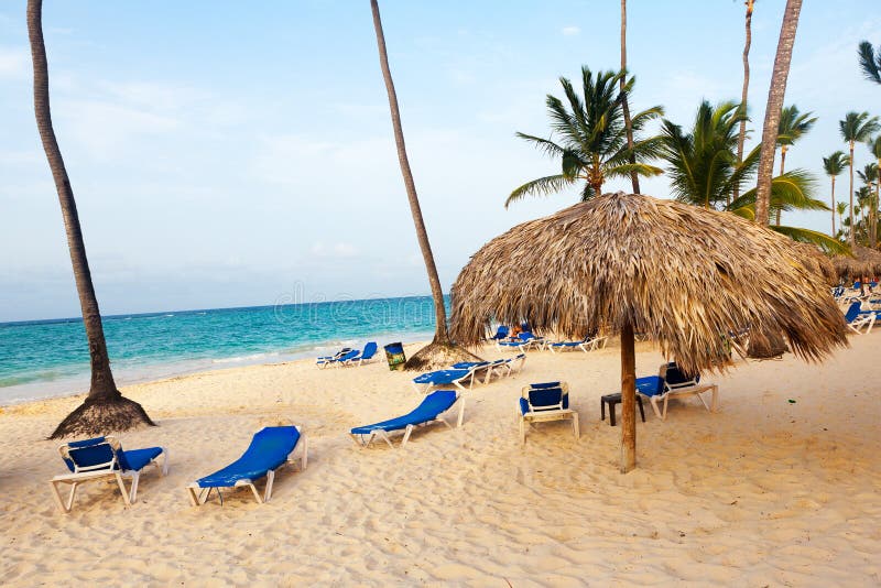 Beach Parasol on the White Sand Beach with Cloudy Blue Sky and Sun ...
