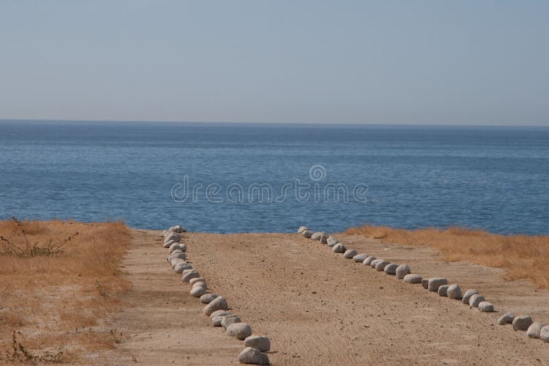 Stone lined path on beach stock photo. Image of beach - 30914218