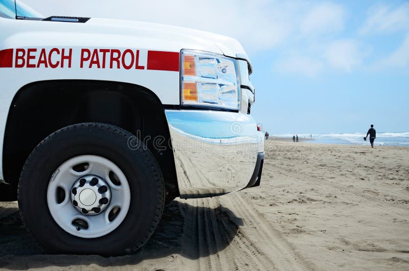Beach Patrol Vehicle at the Ocean Stock Photo - Image of patrol, sand ...