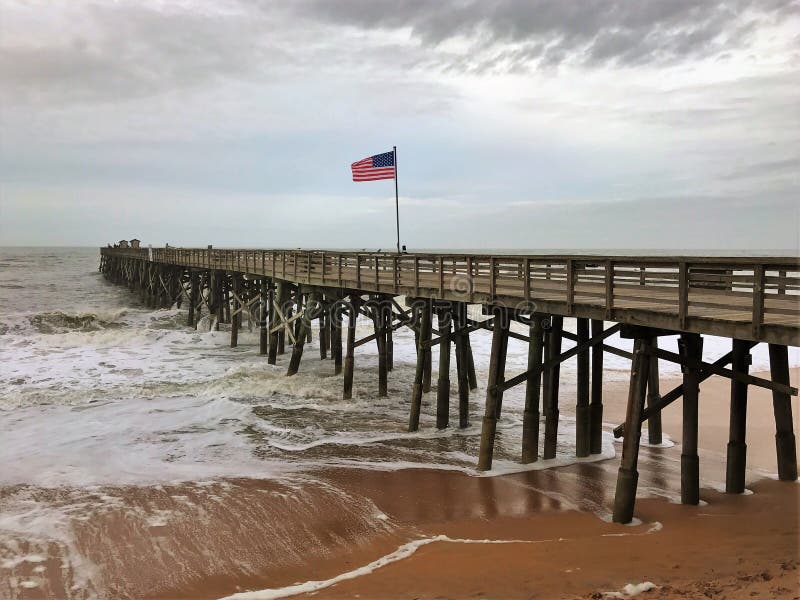 Beach Pier with American Flag Flying Stock Photo - Image of pier, flag ...