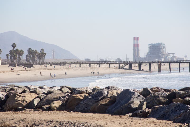 Beach with Pier and Power Plant in Background Stock Photo - Image of ...