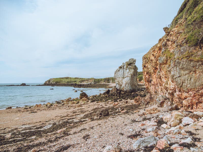The Beach of Porth Padrig in Anglesey, with a Large Rock Formation ...