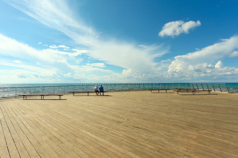 Beach Promenade with Benches and Blue Sky Stock Image - Image of girl ...