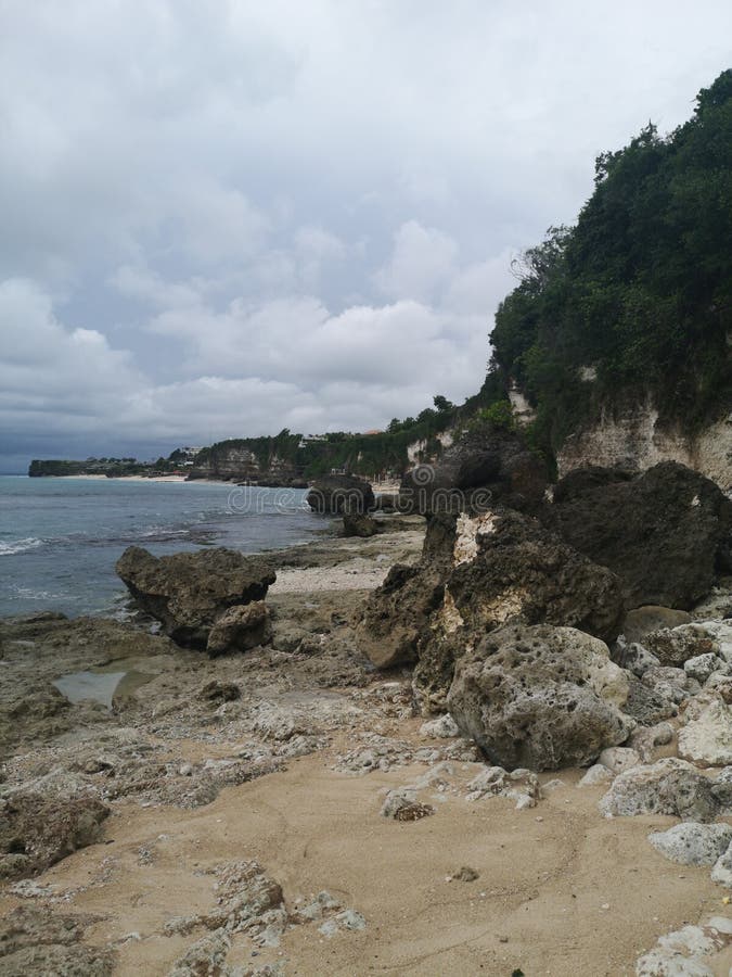 Beach with rocks stock photo. Image of cove, wave, cliff - 203851280