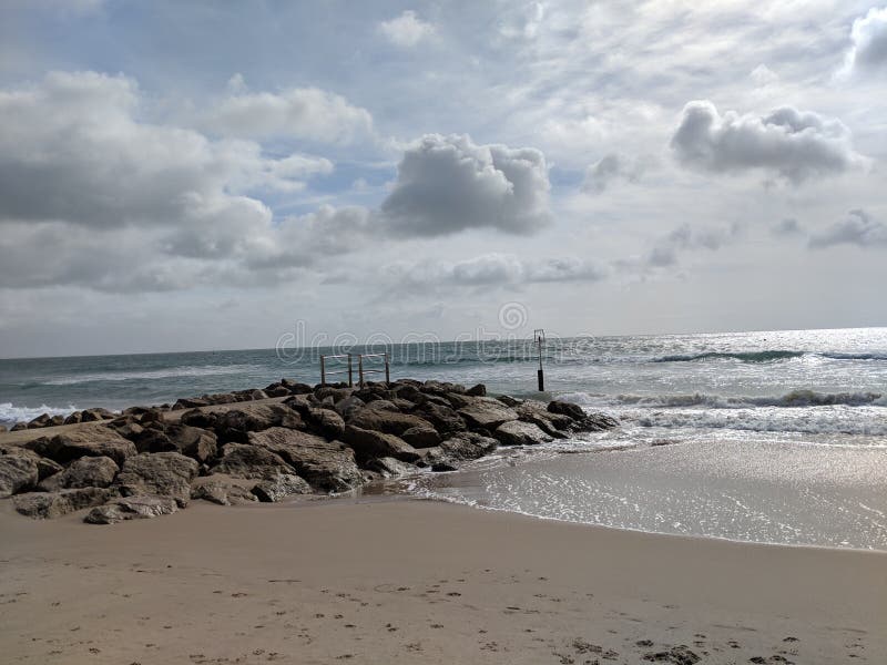 Beach and rocks stock photo. Image of small, pier, rocks - 126554986