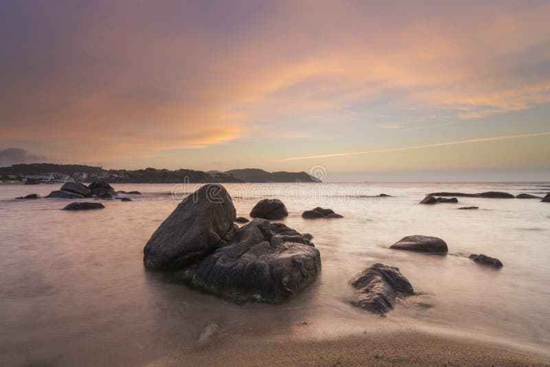 Beach with Rocks and Pink Clouds in the Sky Stock Photo - Image of full ...