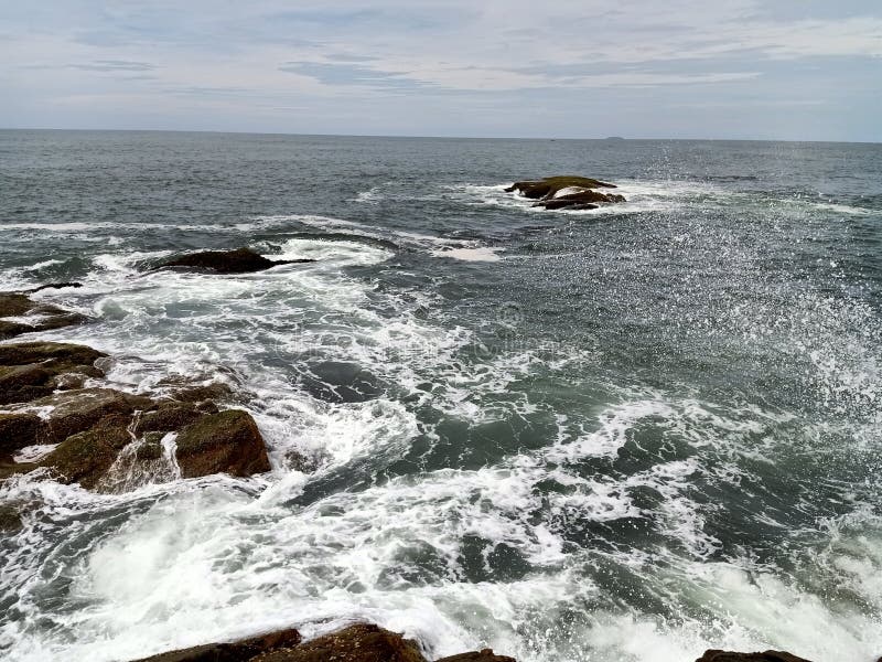 Rocks on beach side stock image. Image of beach, water - 180410773