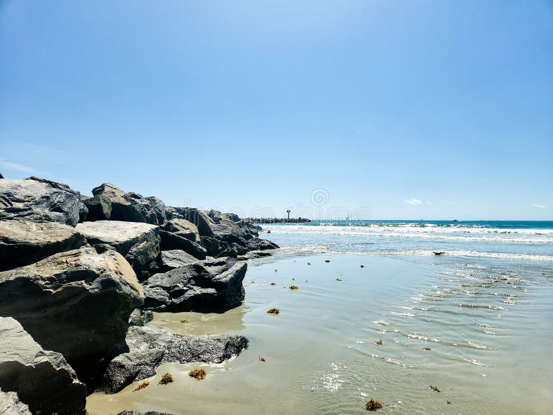 Beach rocks sand ocean stock image. Image of wave, horizon - 265958503