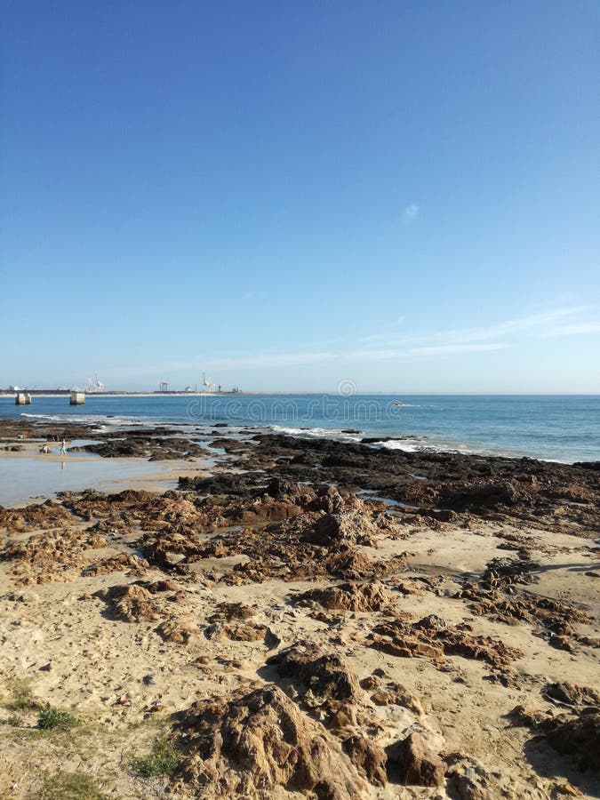 Beach rocks sand shore stock image. Image of shore, rocks - 114415731