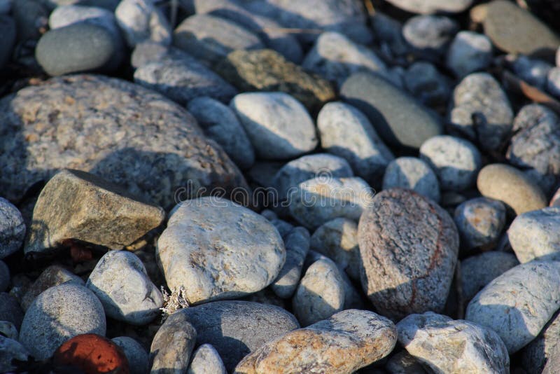 Beach rocks stock photo. Image of rocks, shadows, beach - 75111176
