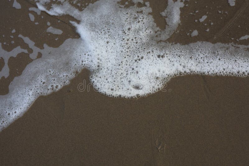 Beach sand and foam waves stock image. Image of water - 278208351