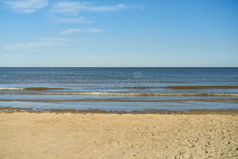 Beach with Sand in Front of Sea and Sky with Clouds Stock Image - Image ...