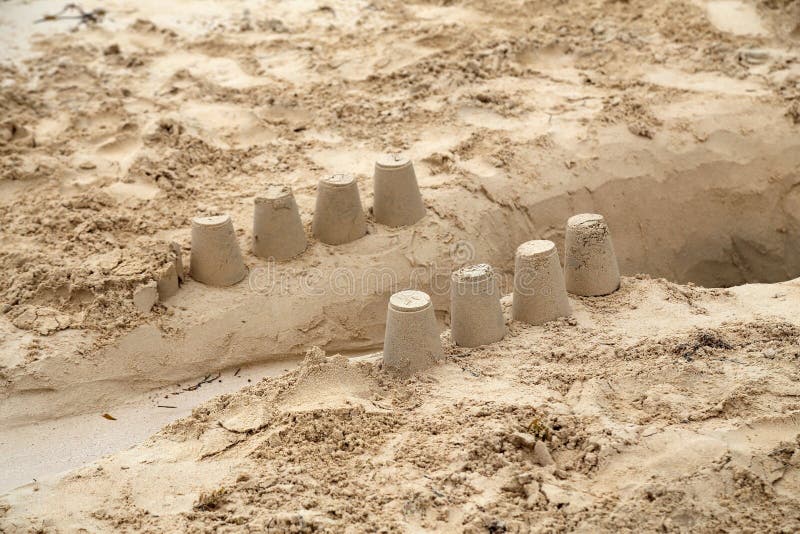 Sand games on the beach stock image. Image of water - 127439607