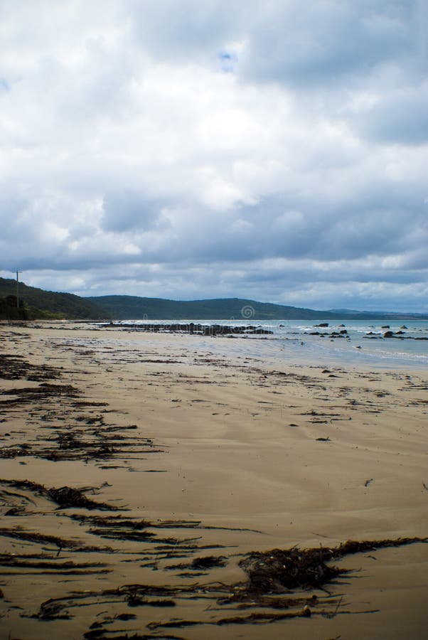 Beach with Sand, Ocean and an Overcast Sky Stock Image - Image of ...