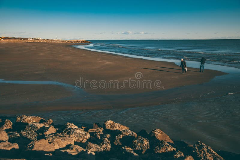 Beach with Sand, Panorama, at Low Tide People Walk on the Shore Looking ...