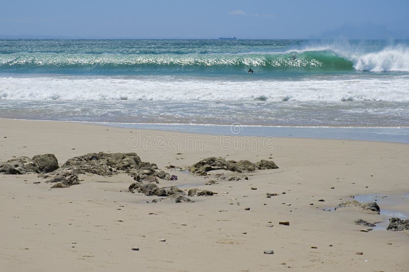 Beach Scene with Rocks in the Foreground and Waves Breaking in the ...