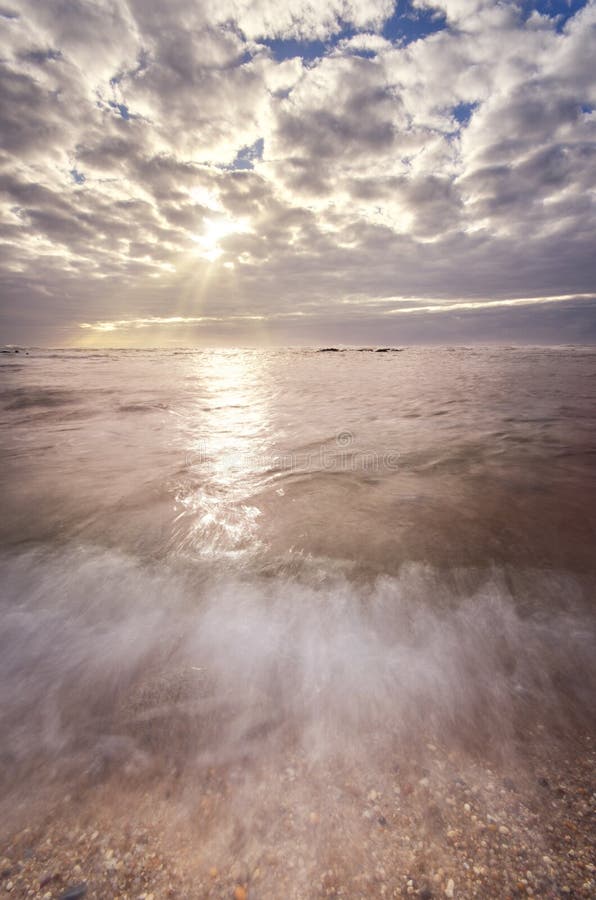 Beach Scene with Sun Beams in the Horizon Stock Photo - Image of sand ...