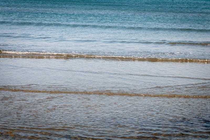 Beach with Shallow Water and Small Waves. Stock Photo - Image of ...